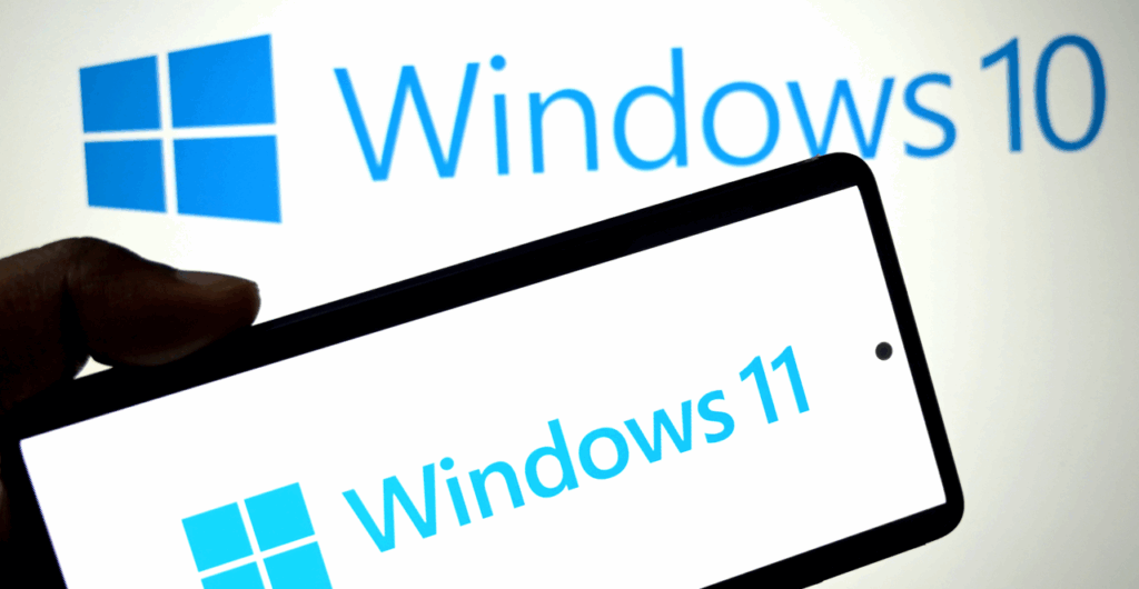 Windows 10 logo on a wall, with a phone displaying Windows 11 logo ...
